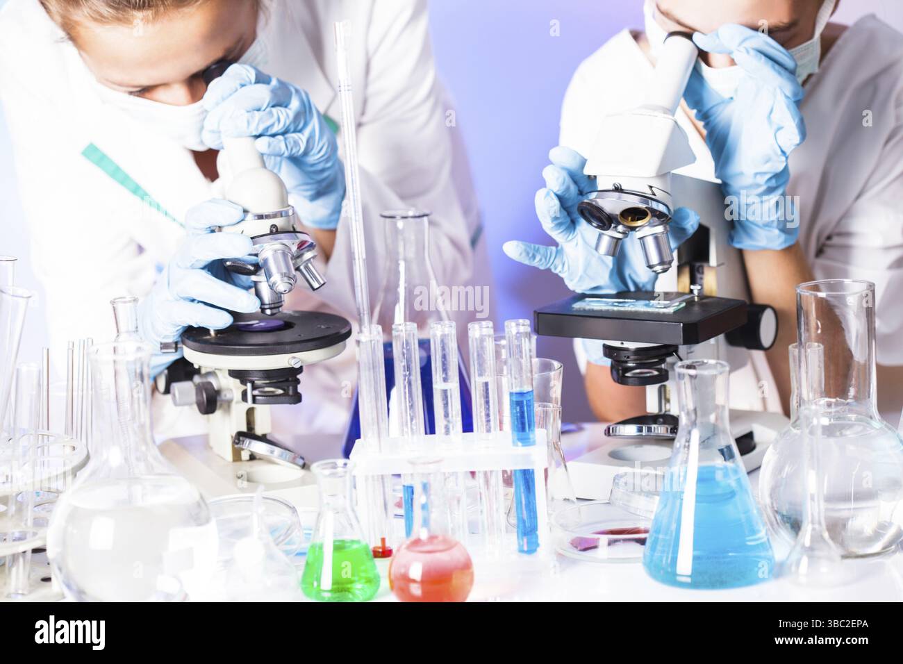 Two scientists in the chemical laboratory are doing experiments Stock ...