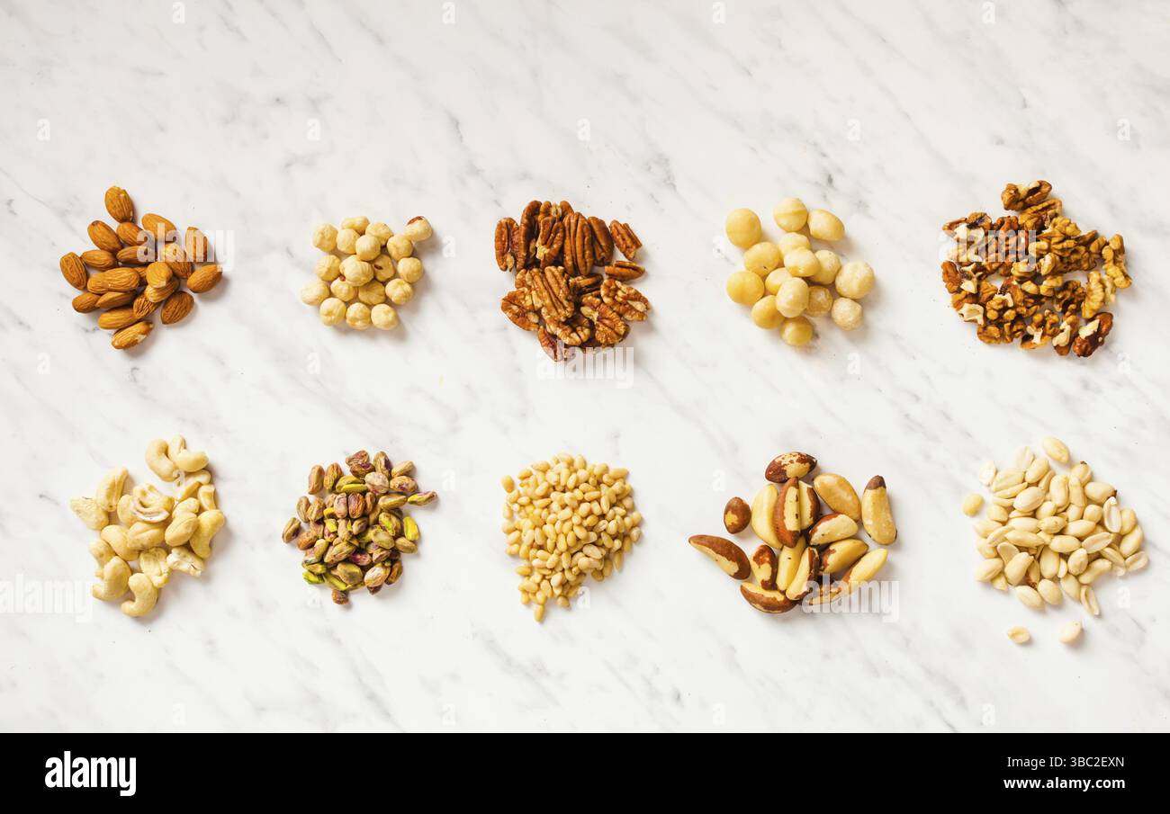 Heaps of various types of nuts, natural protein, healthy snack top view ...