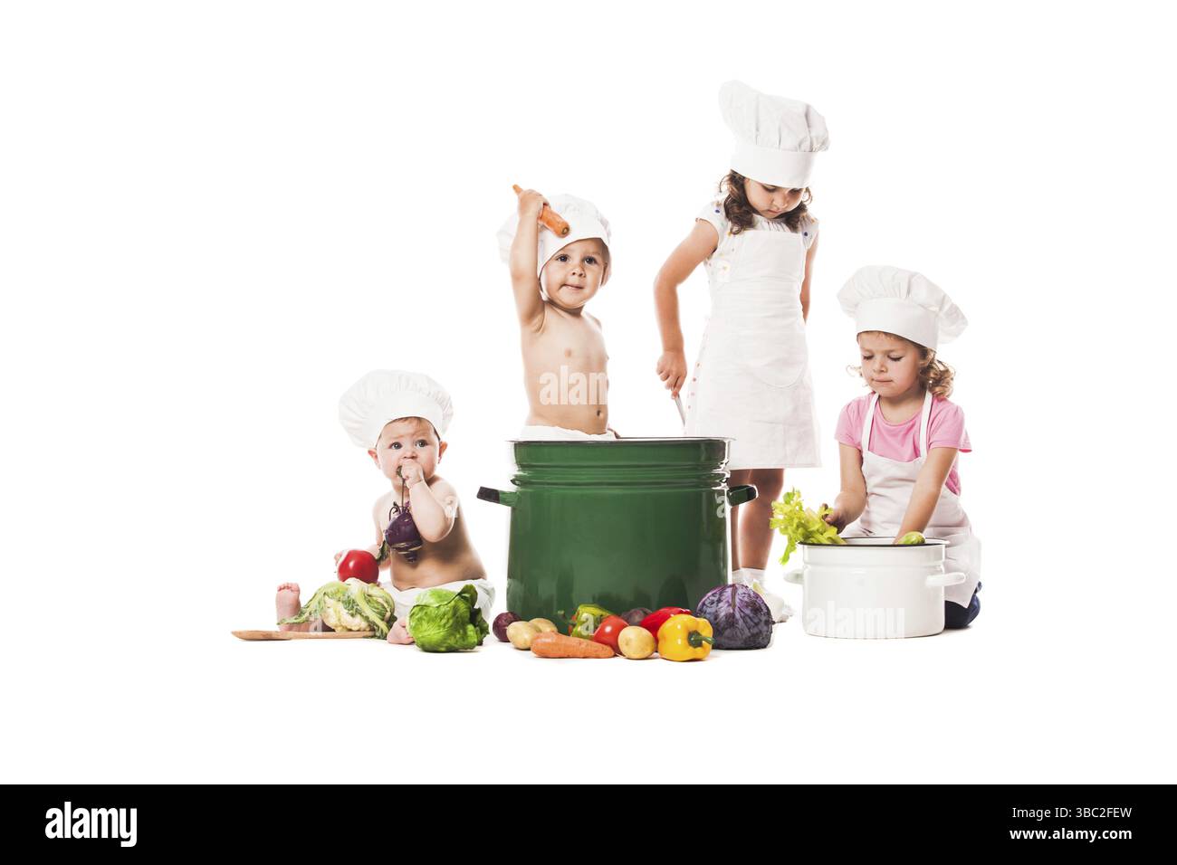 Group of kids play and cook with vegetables. Little chefs isolated on ...