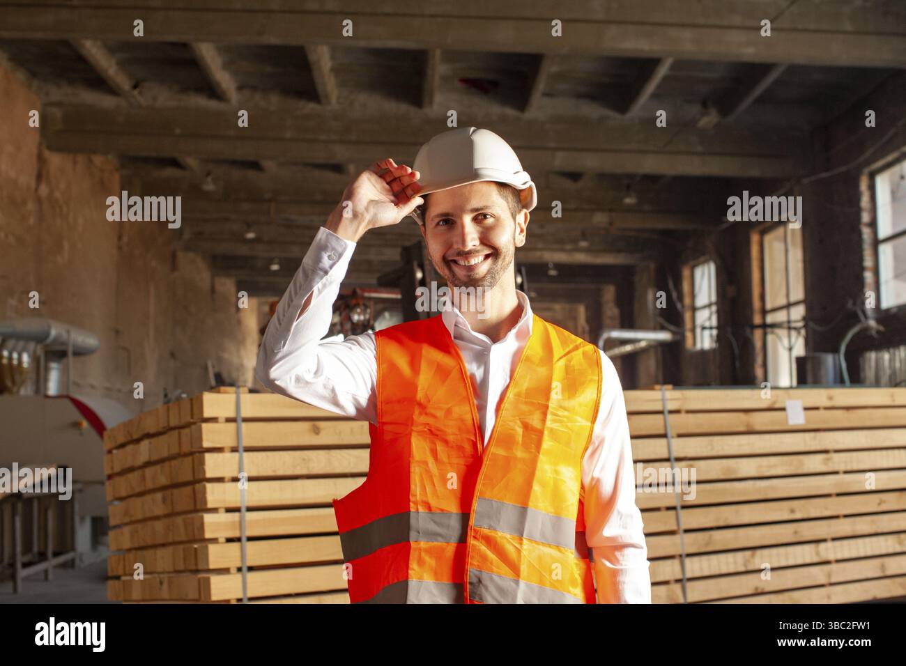Portrait of young smiling technician employee of woodworking factory ...