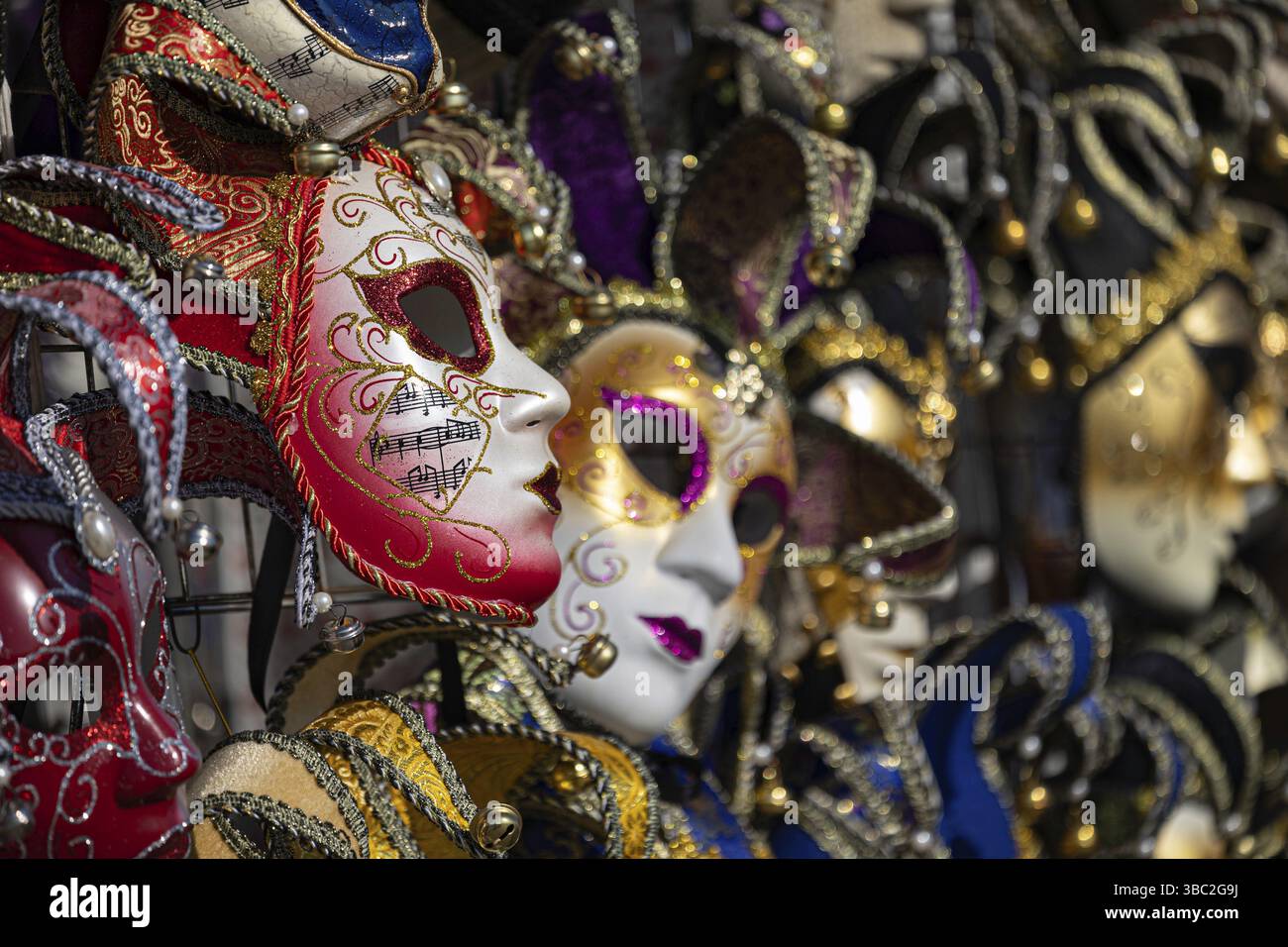 Venetian carnival masks in various colours and patterns, artfully and ...