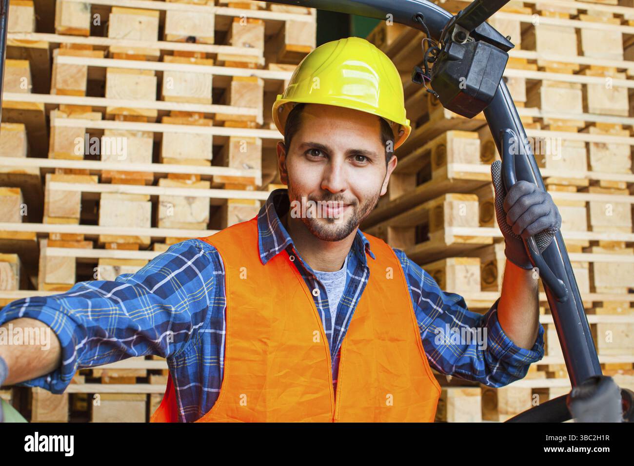 Workman wears protective helmet hi-res stock photography and images - Alamy