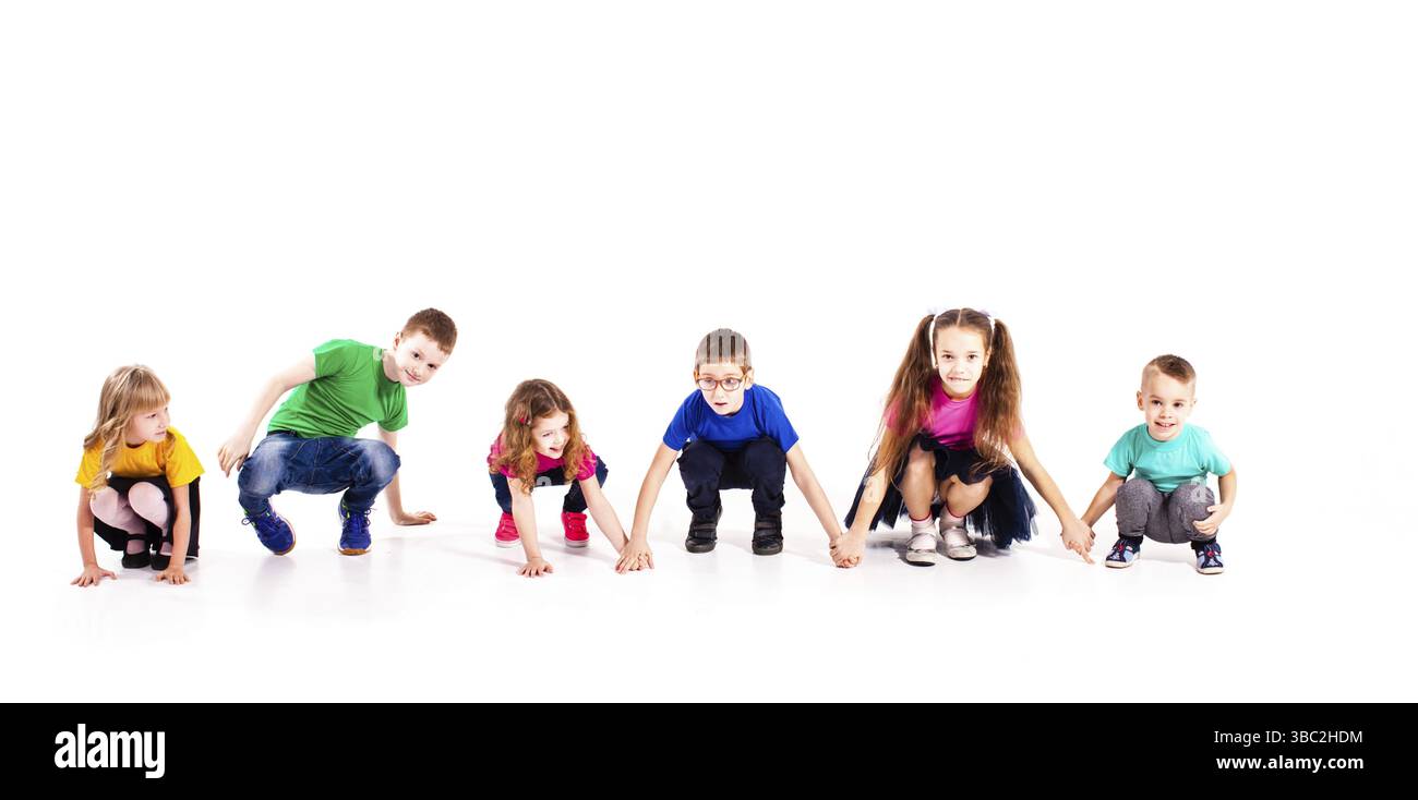 The cute boys and girls are jump by holding hands isolated on white ...