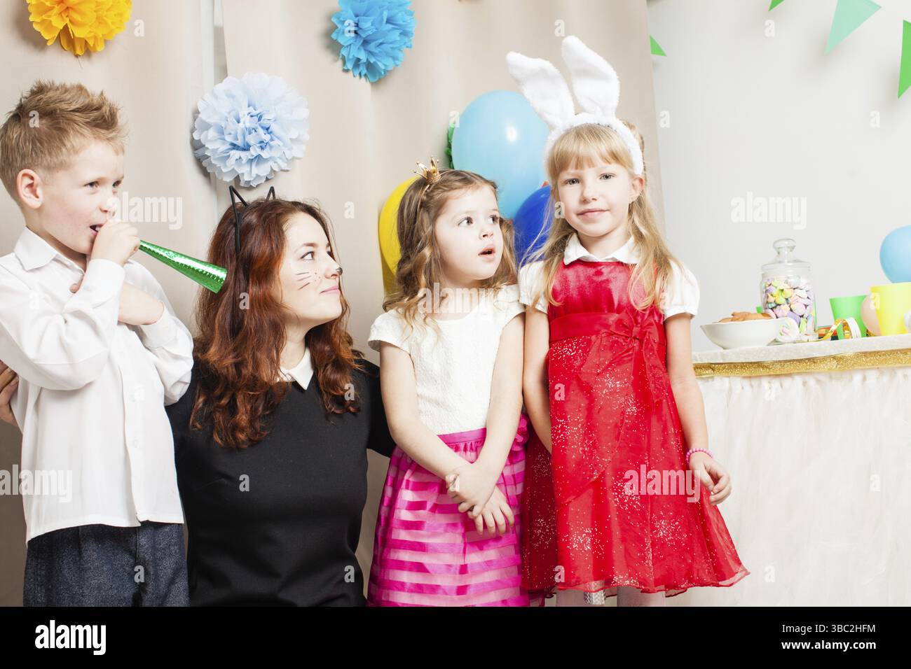 Cute kids playing with animator on the birthday party. Cat woman ...