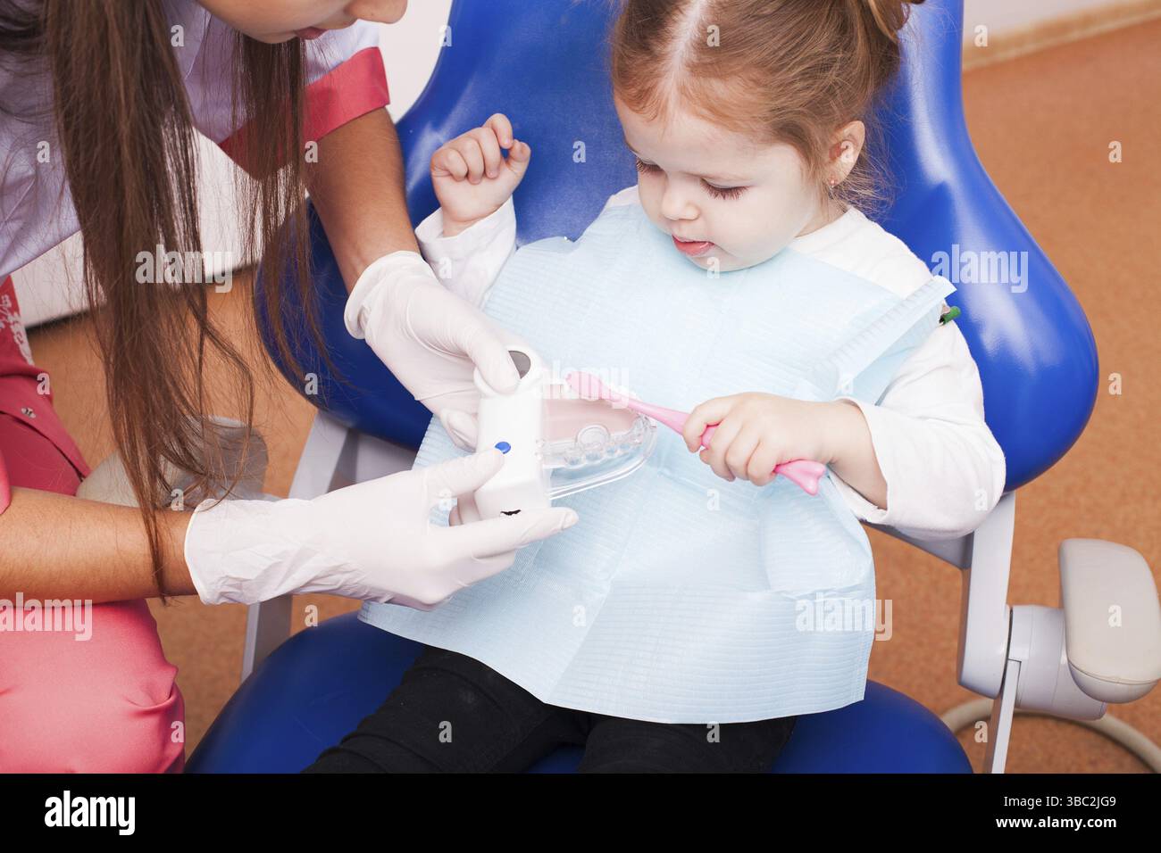 Two years old girl is learning to brush her teeth with toothbrush in ...