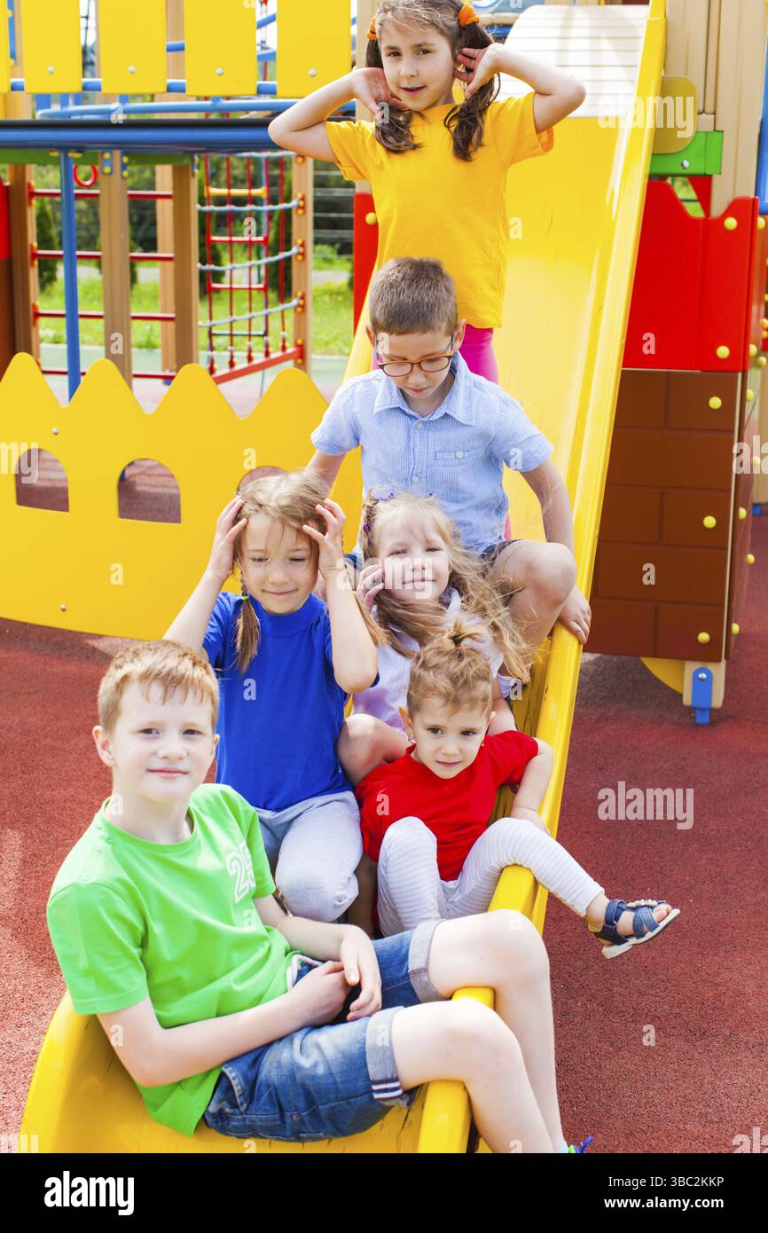 Children at the playground sitting on the slide. Concept of traffic jam ...