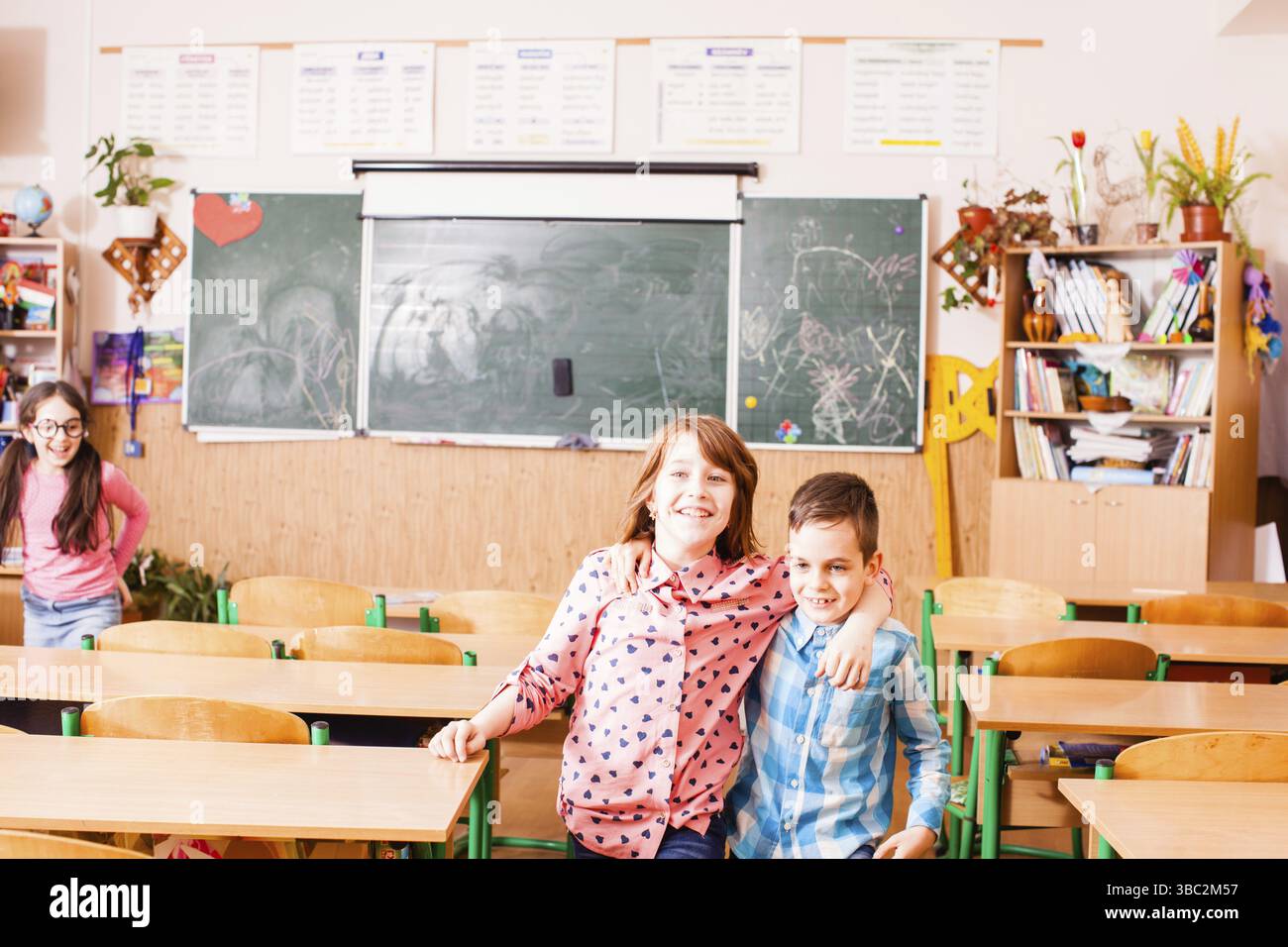 Two best friends hugging and fun smiling in classroom Stock Photo - Alamy