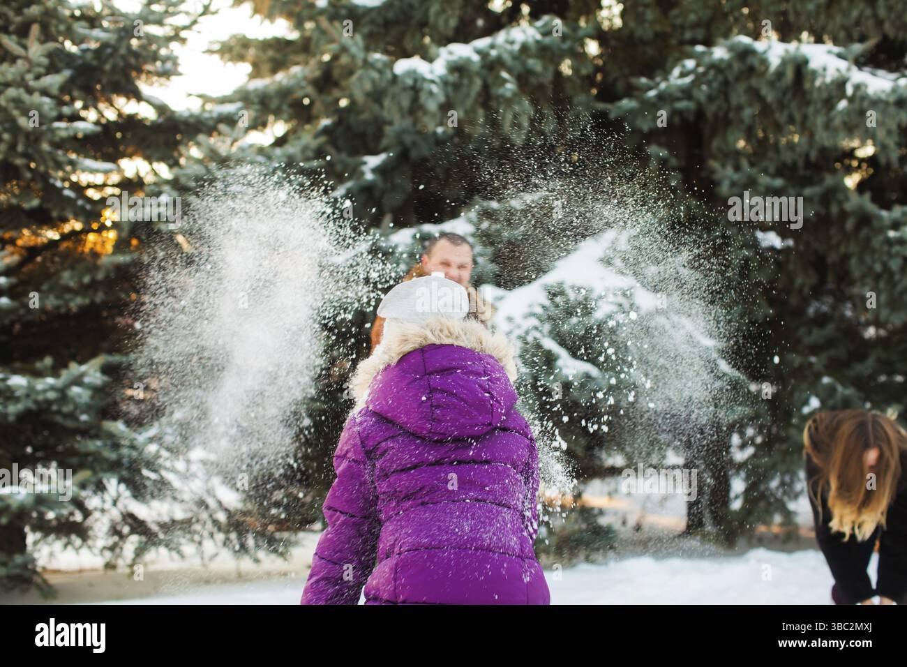 Joyful daughter throwing snowball hi-res stock photography and images ...