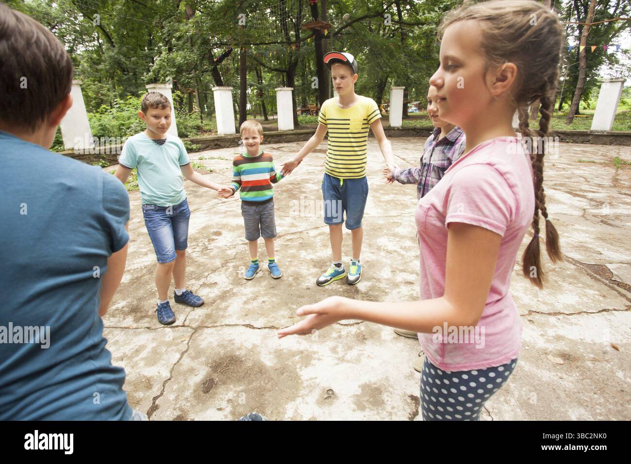 Children playing the game outdoors clapping hands in a circle Stock ...