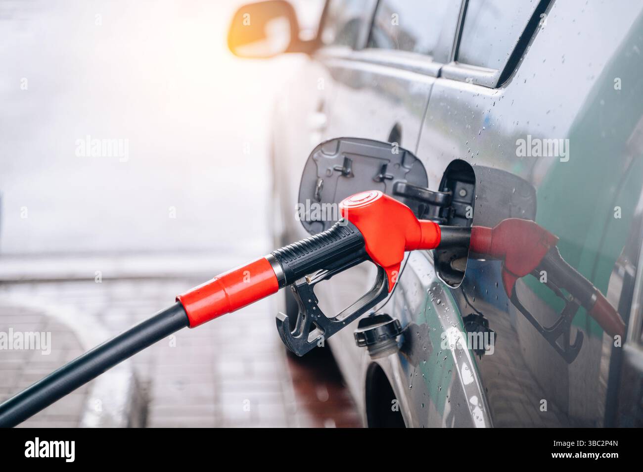 Fill the car with fuel. The car is filled with gasoline at a gas ...