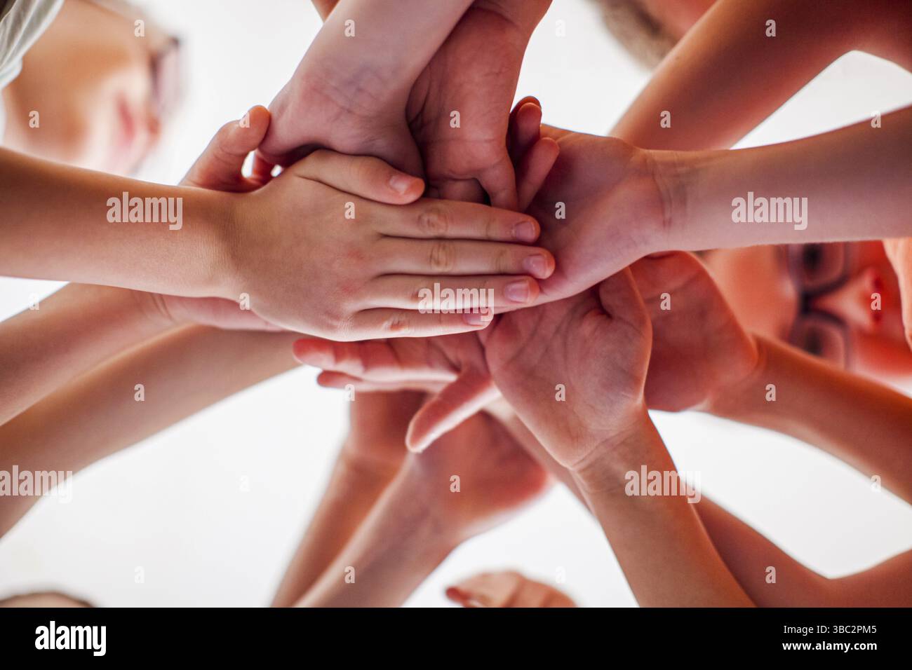 Close up children hands together, view from down. Friendship ...