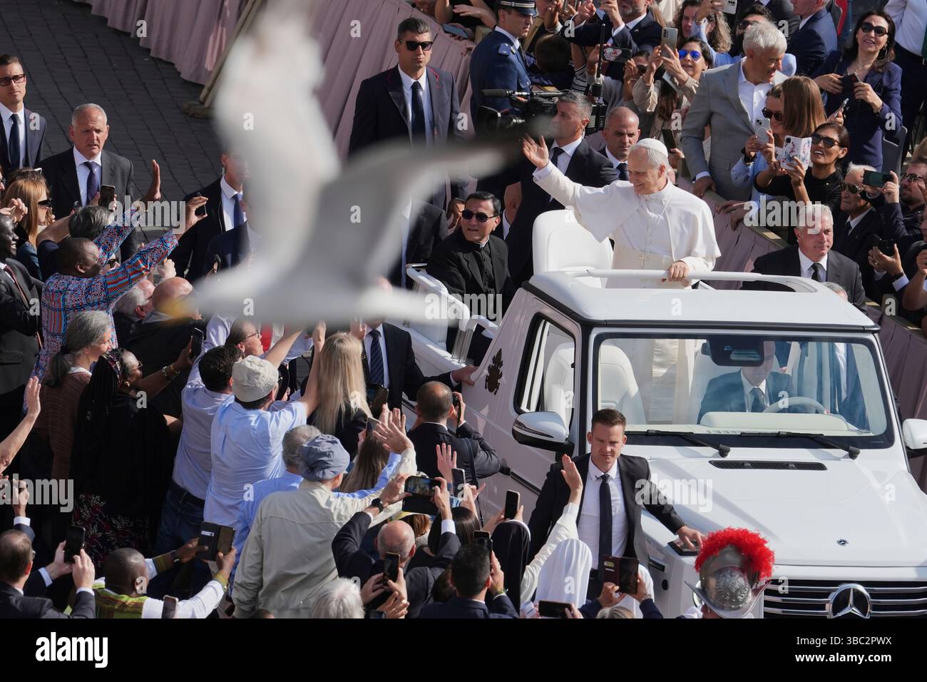 A bird flies by as Pope Leo XIV on his popemobile tours St. Peter's ...