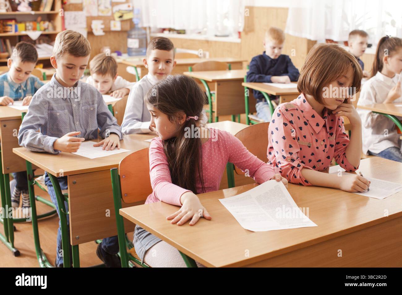 Children of primary school taking an exam writing school test Stock ...