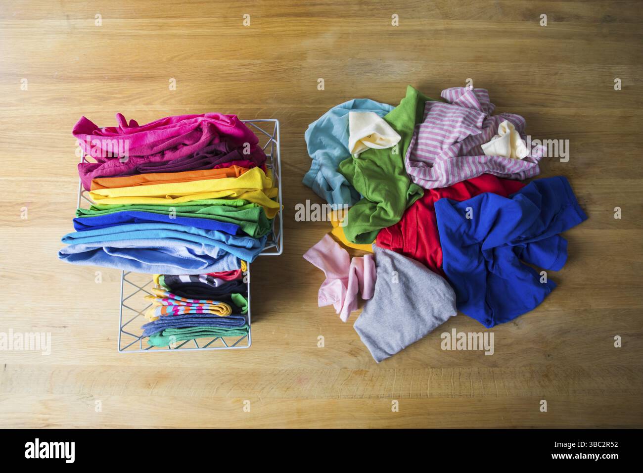 Top view laundry organised in folders. Arranging clothes according to ...