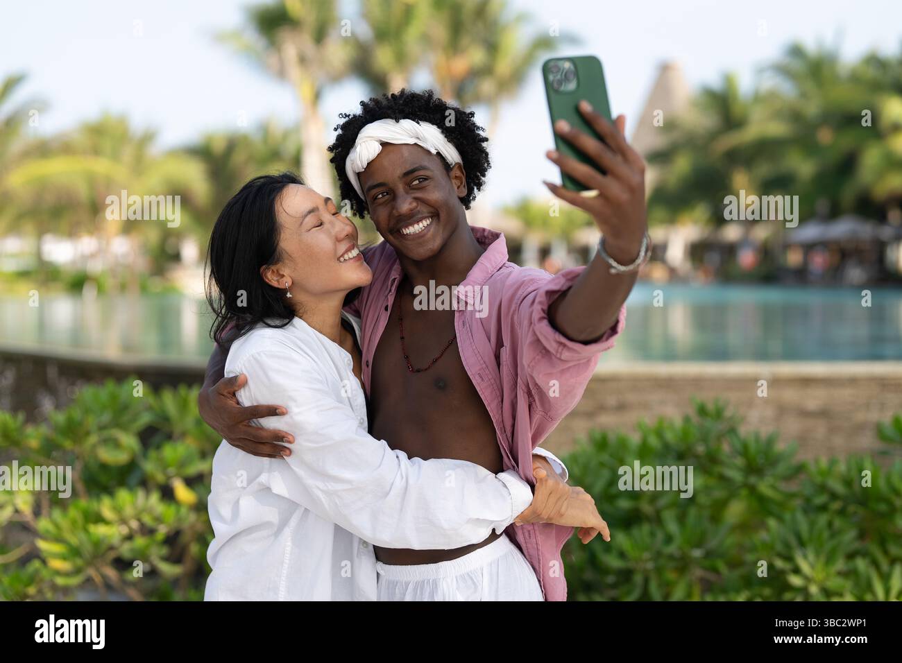 Diverse couple connected, embracing technology and social media while ...