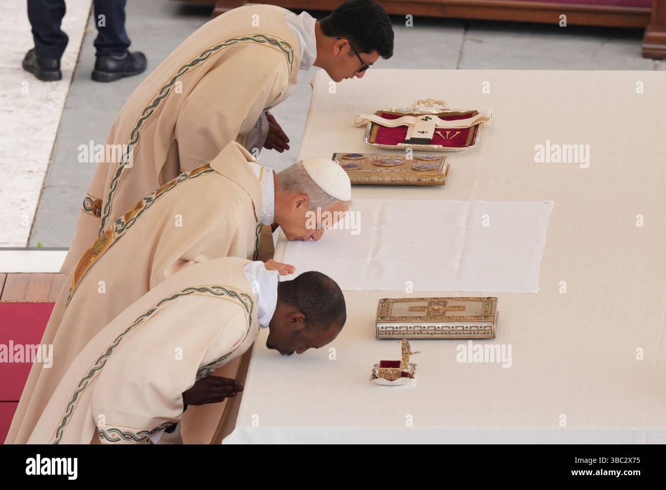 Pope Leo XIV, center, kisses the pallium, or lambswool stole, a symbol ...