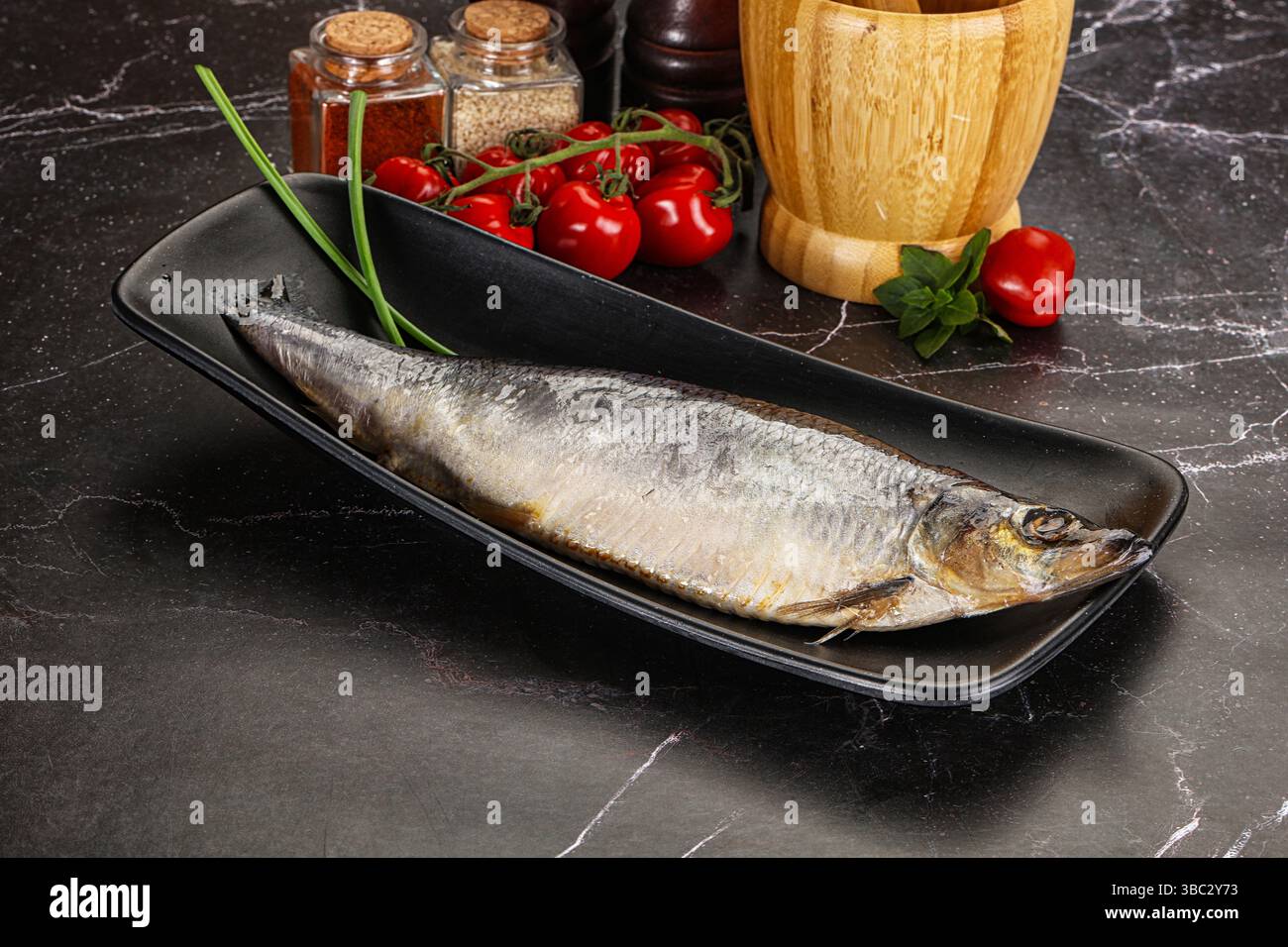 Whole raw salted herring fish in the plate Stock Photo - Alamy