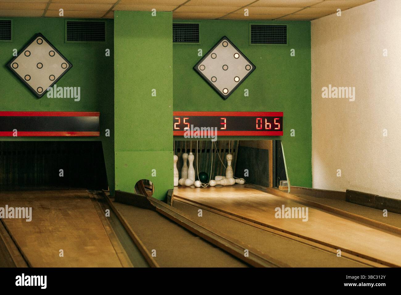 Vintage-style German Kegeln game setup with ten pins, a green ball, and ...