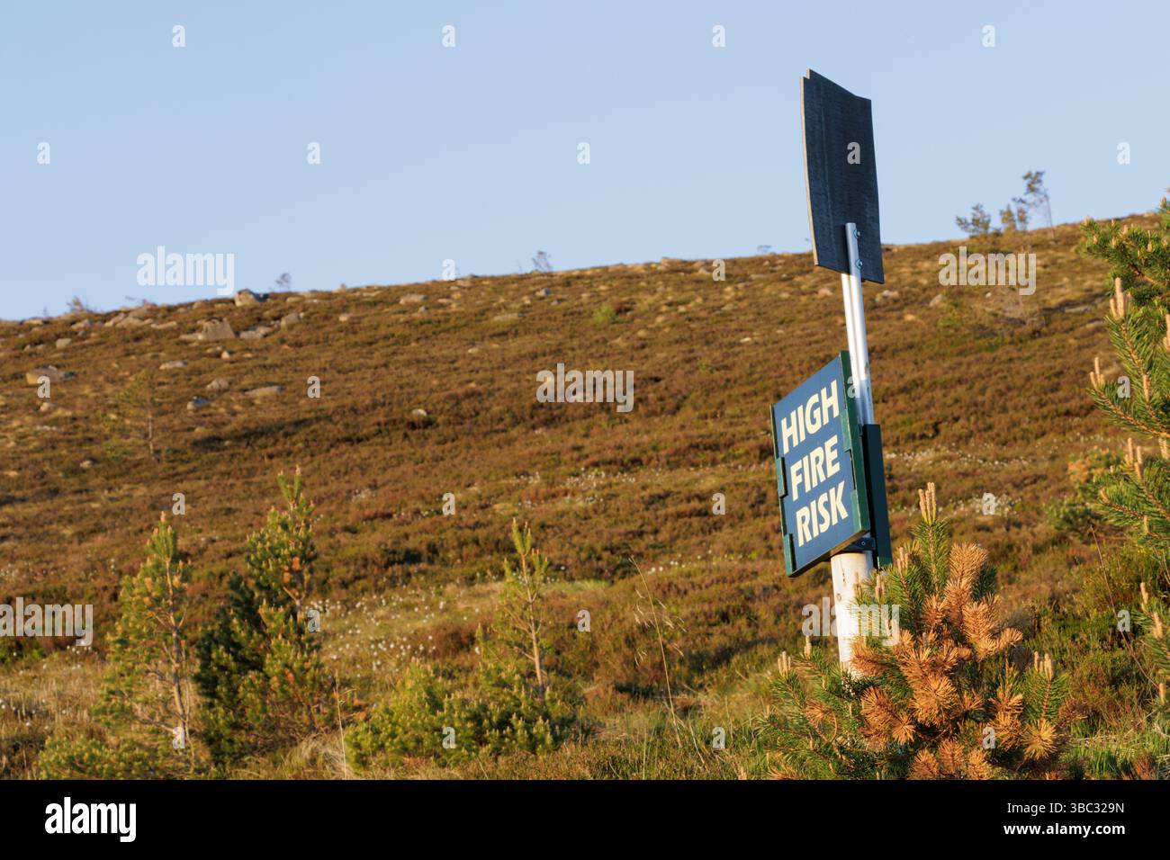 High fire risk sign and beaters on Scottish mountain by shrub Stock ...