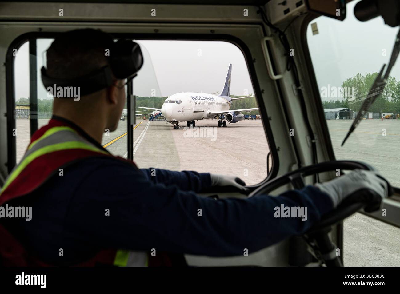 Mirabel, Canada. 17th May, 2025. A ground crew looks over at a 42 year ...
