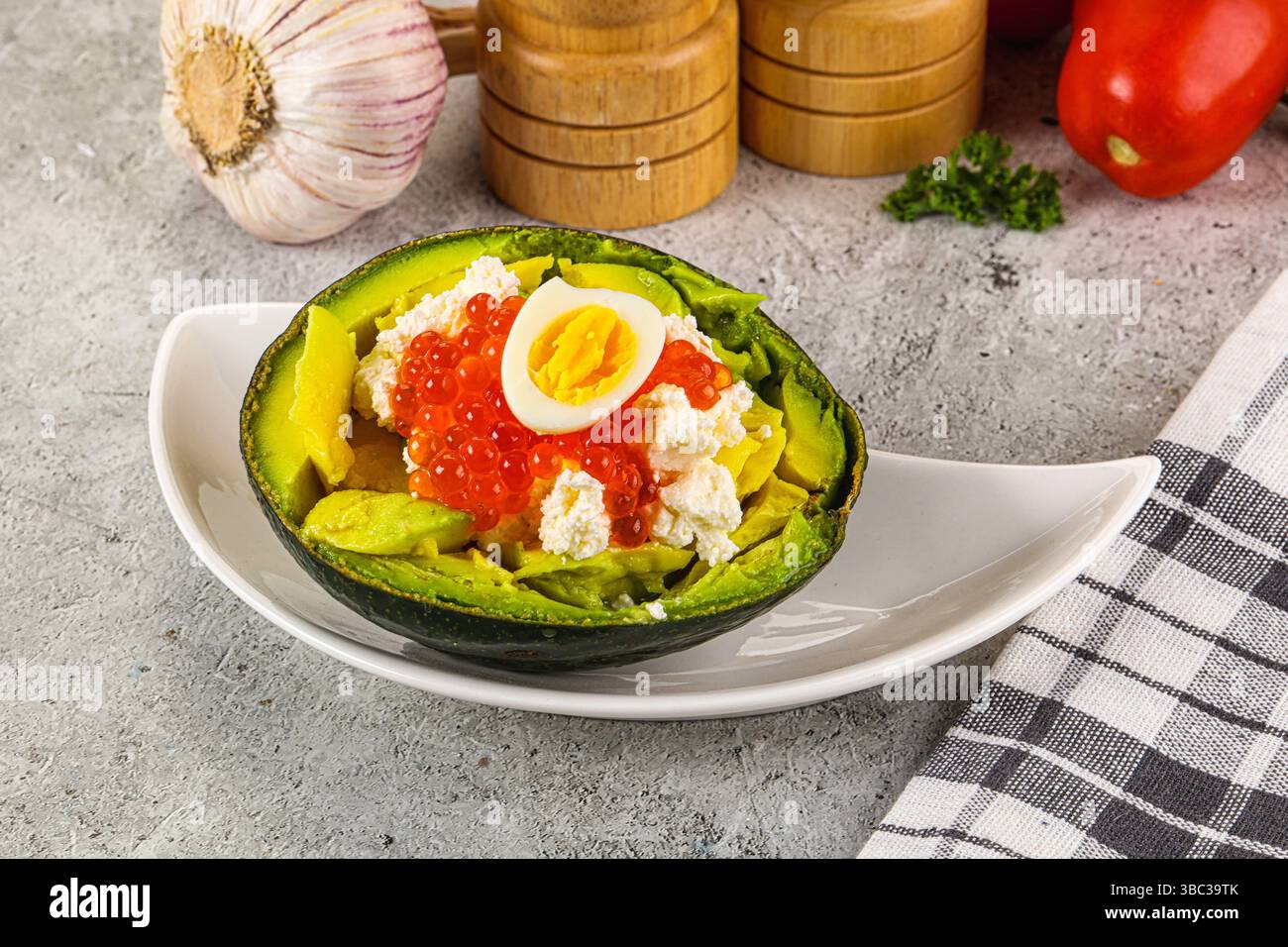 Avocado with red caviar and quil egg and soft cheese Stock Photo - Alamy