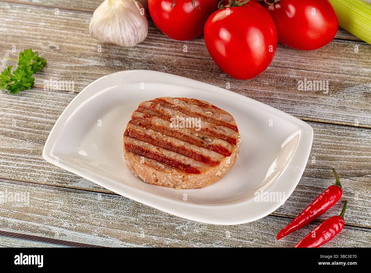 Grilled tuna steak fillet round medallion Stock Photo - Alamy