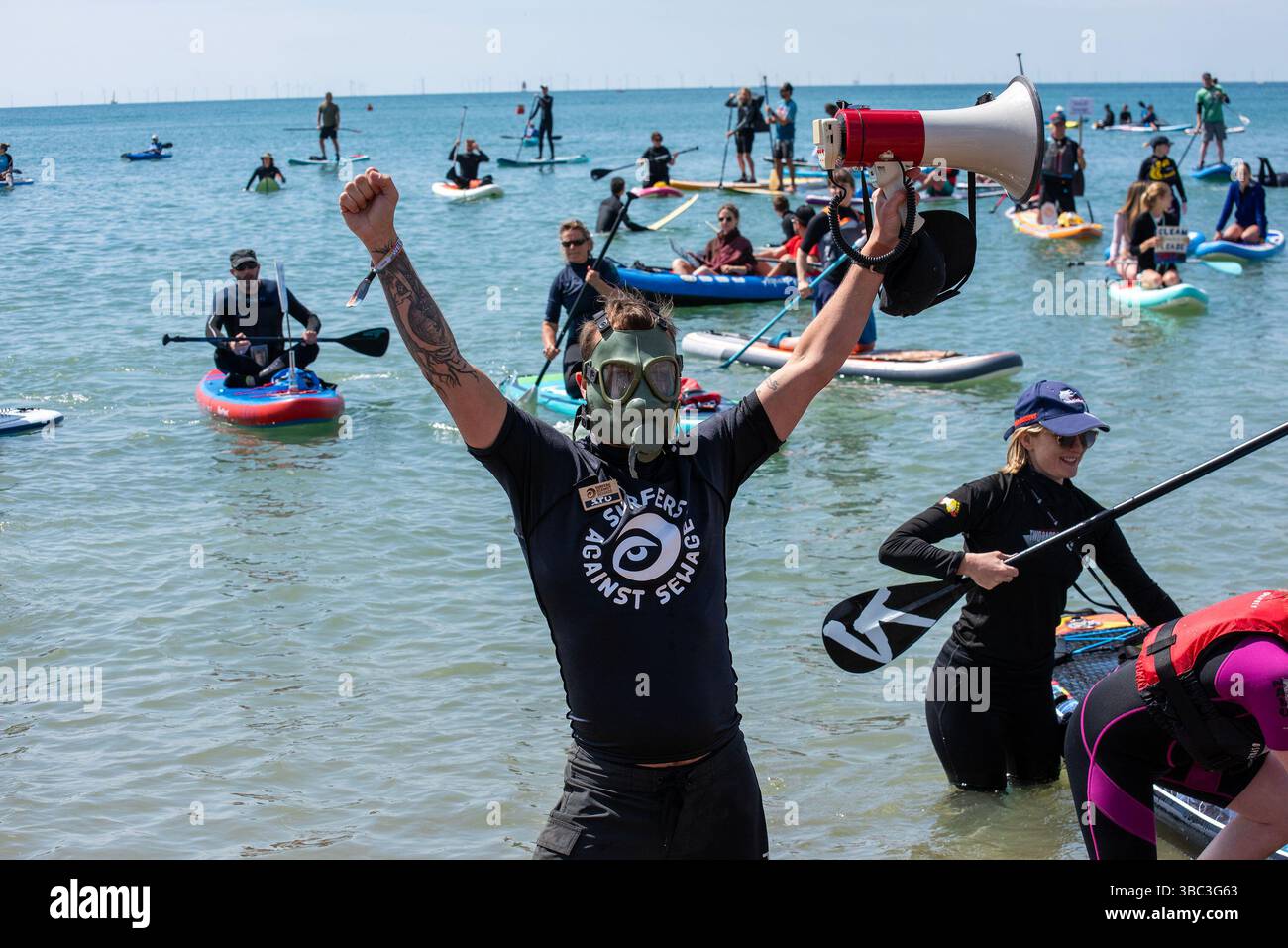 Brighton, UK. 17th May, 2025. A protester wears a gas mask during the ...