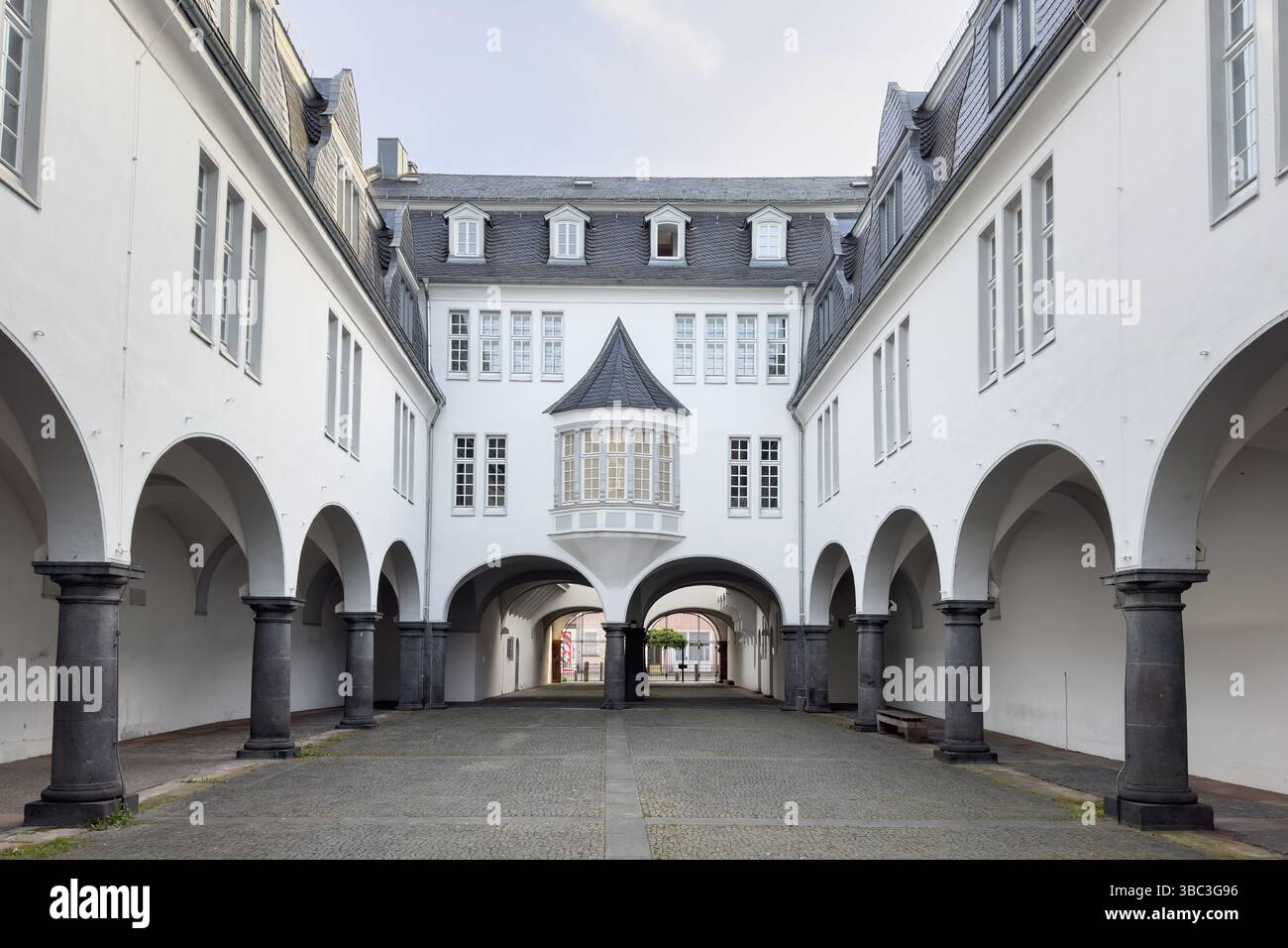 White facades and arched columns define this charming courtyard in ...