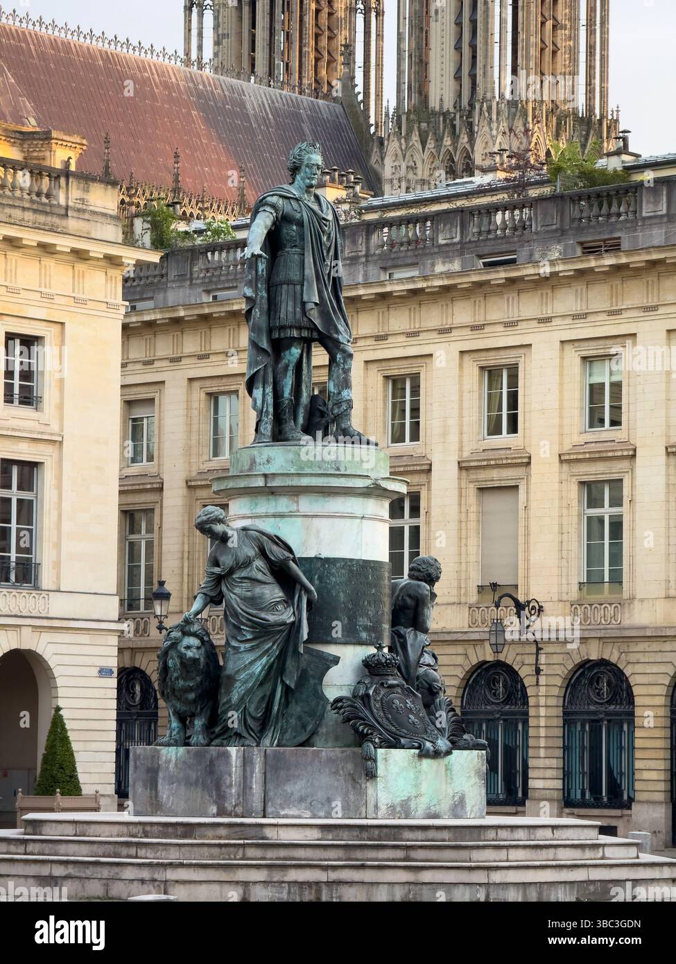 A historic statue prominently displays figures in Reims, France, with ...