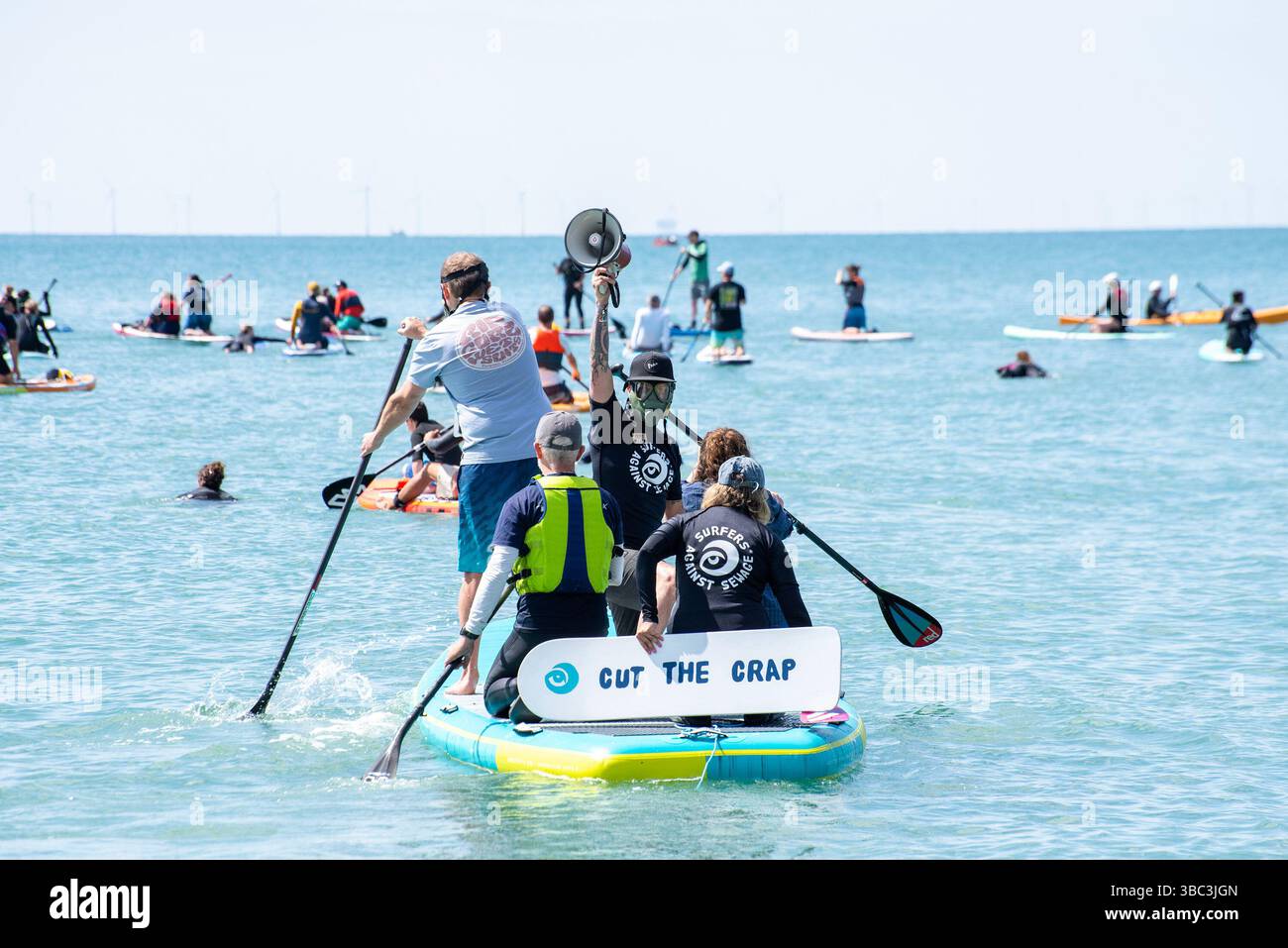 Brighton, UK. 17th May, 2025. Protesters paddle out to the open sea ...