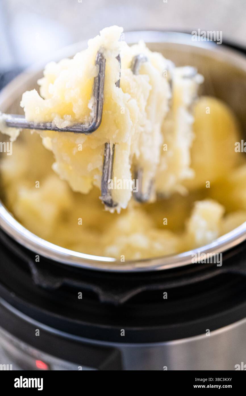Whipping Up Creamy Mashed Potatoes in Modern Kitchen Stock Photo - Alamy