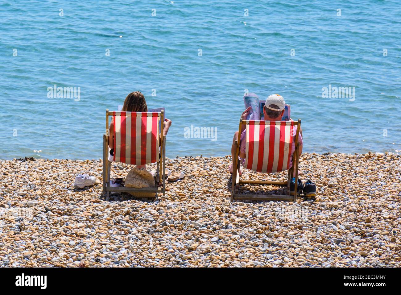 Lyme Regis, Dorset, UK. 18th May, 2025. UK Weather. Sunbathers flock to ...