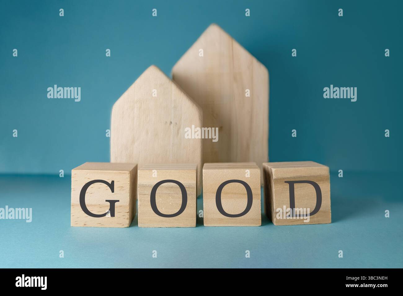 Wooden block with the word GOOD written on it. There are four blocks in ...