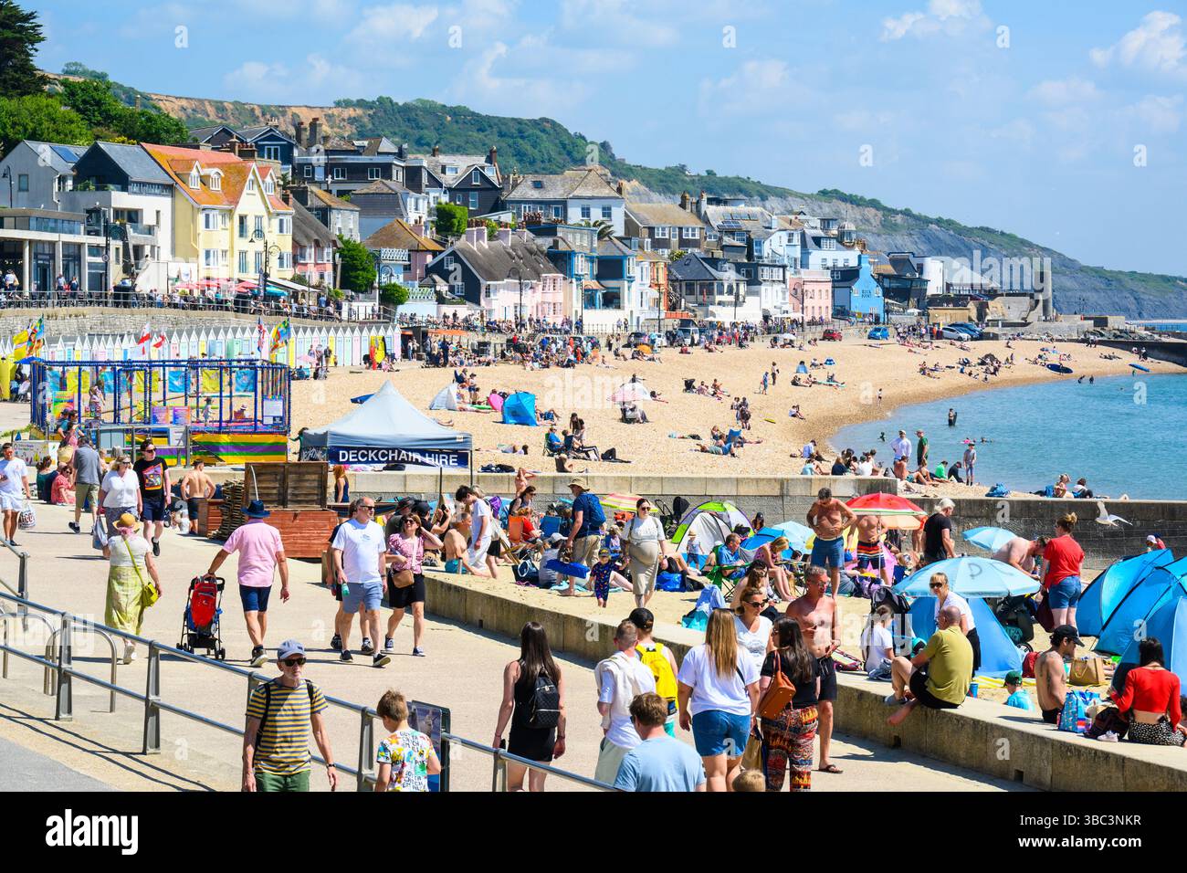 Lyme Regis, Dorset, UK. 18th May, 2025. UK Weather. Sunbathers flock to ...