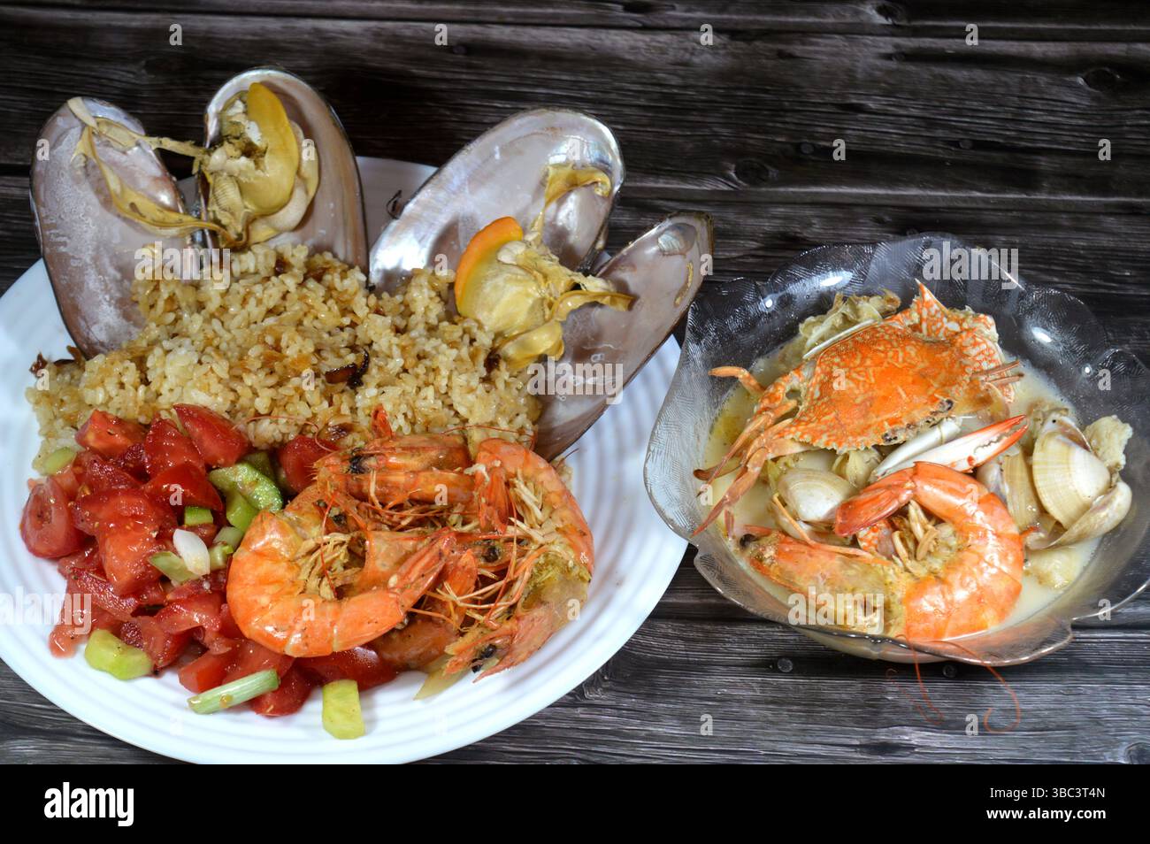 a meal of seafood of Fish rice, green salad, grilled unpeeled shrimps ...