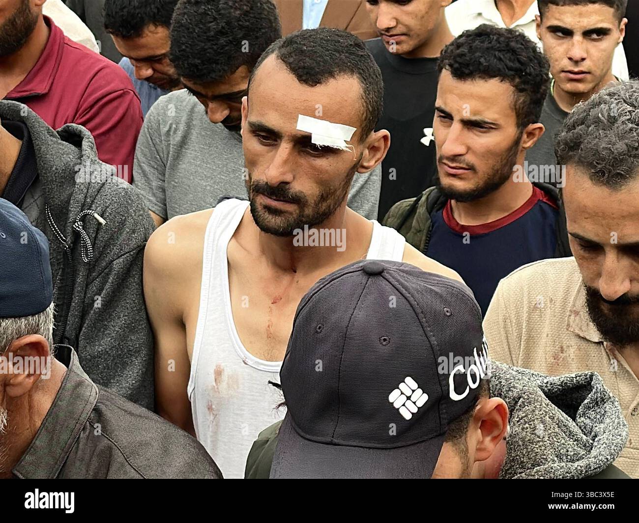 Palestinians mourn by the bodies of relatives who were killed in Israeli strikes, at Nasser ...