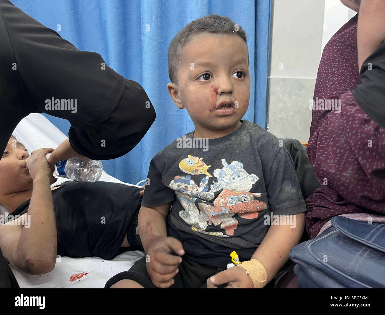 Palestinians transport the wounded to Al-Shifa Hospital after an ...