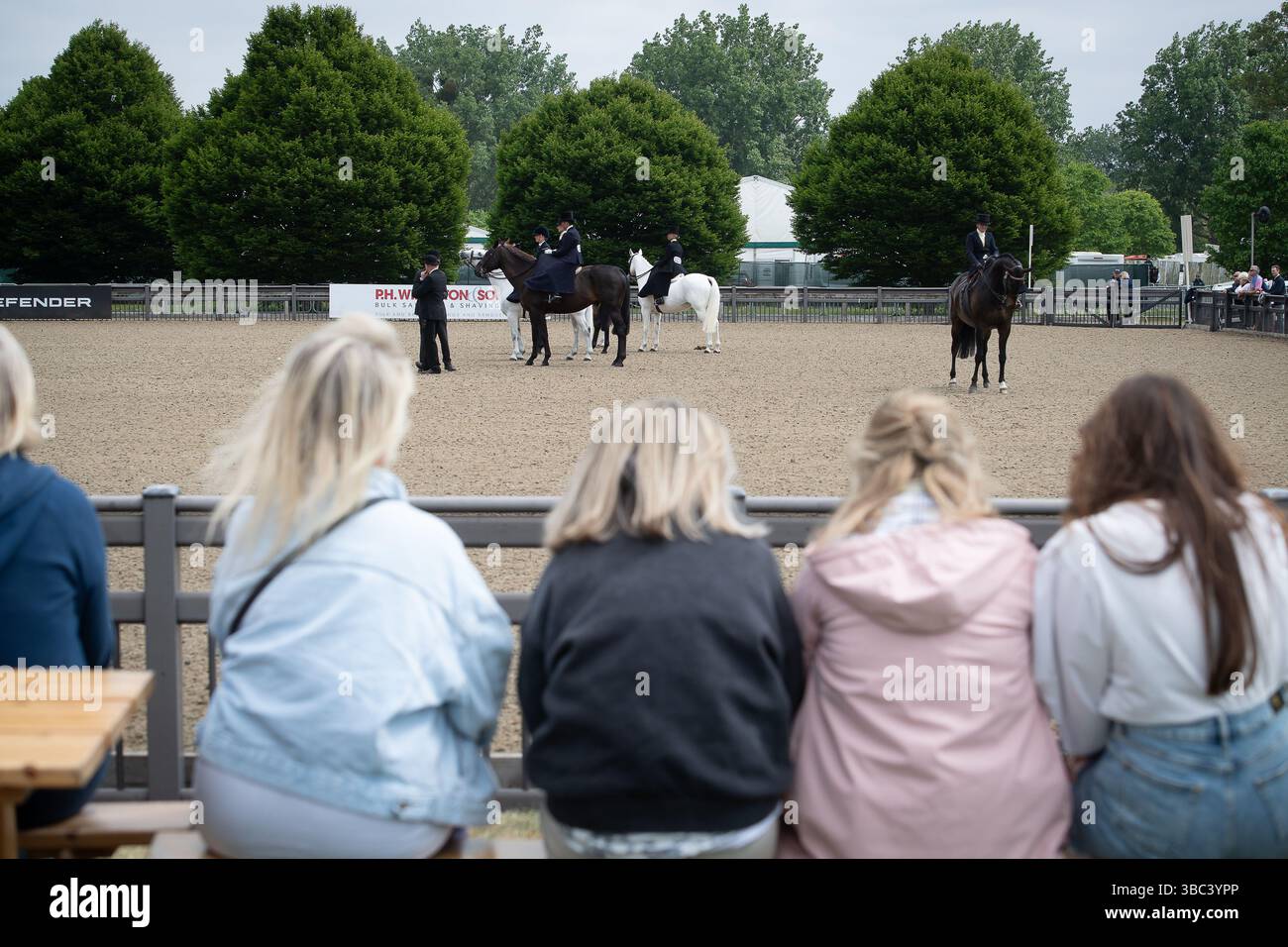 Windsor, Berkshire, UK. 18th May, 2025. Spectators watch ladies riding ...