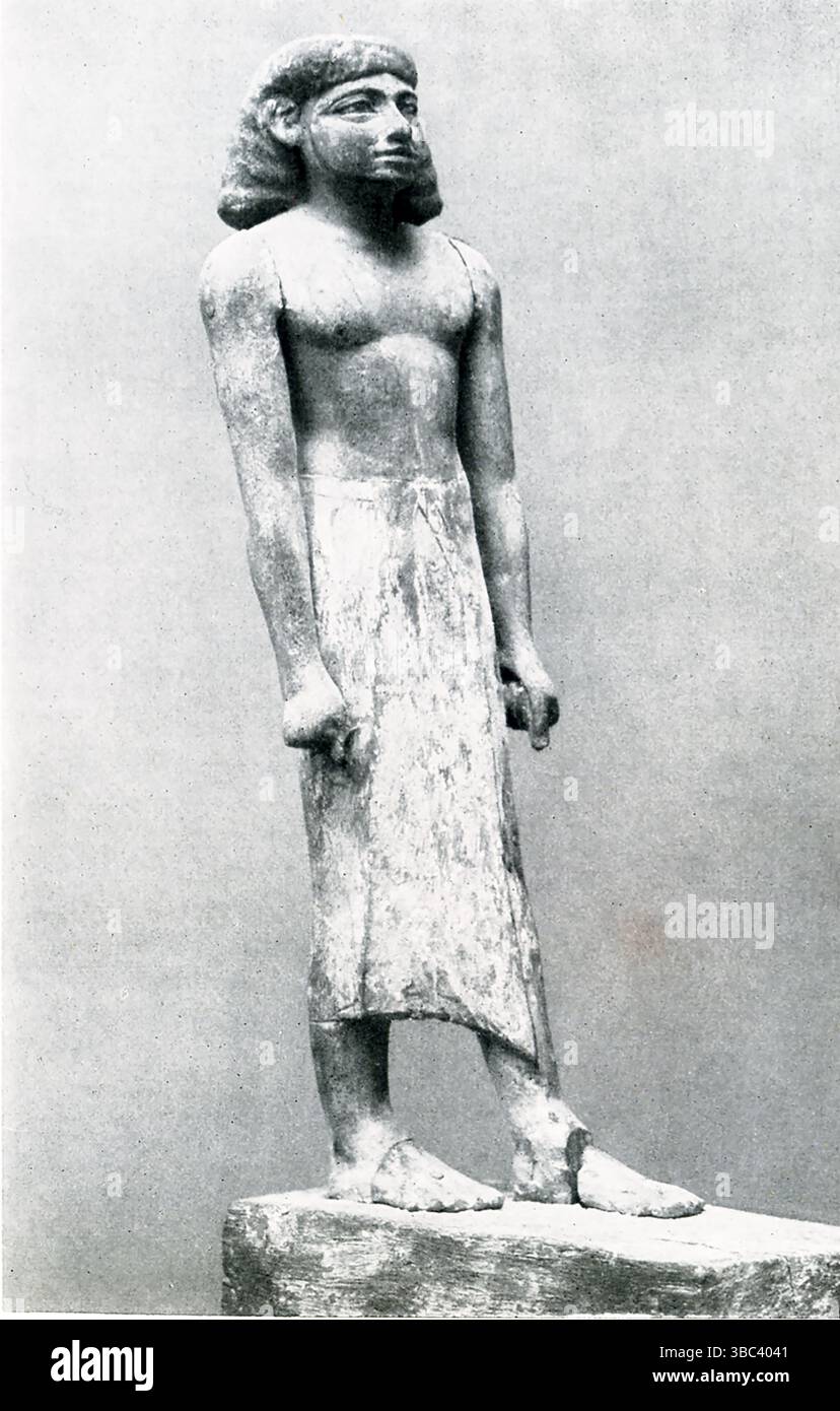 This photo dating to early 1920s shows a carved wooden figure of a man ...