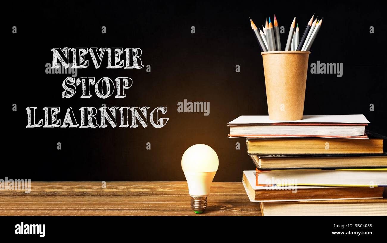 Stack of books with a light bulb on top of them and the words Never ...