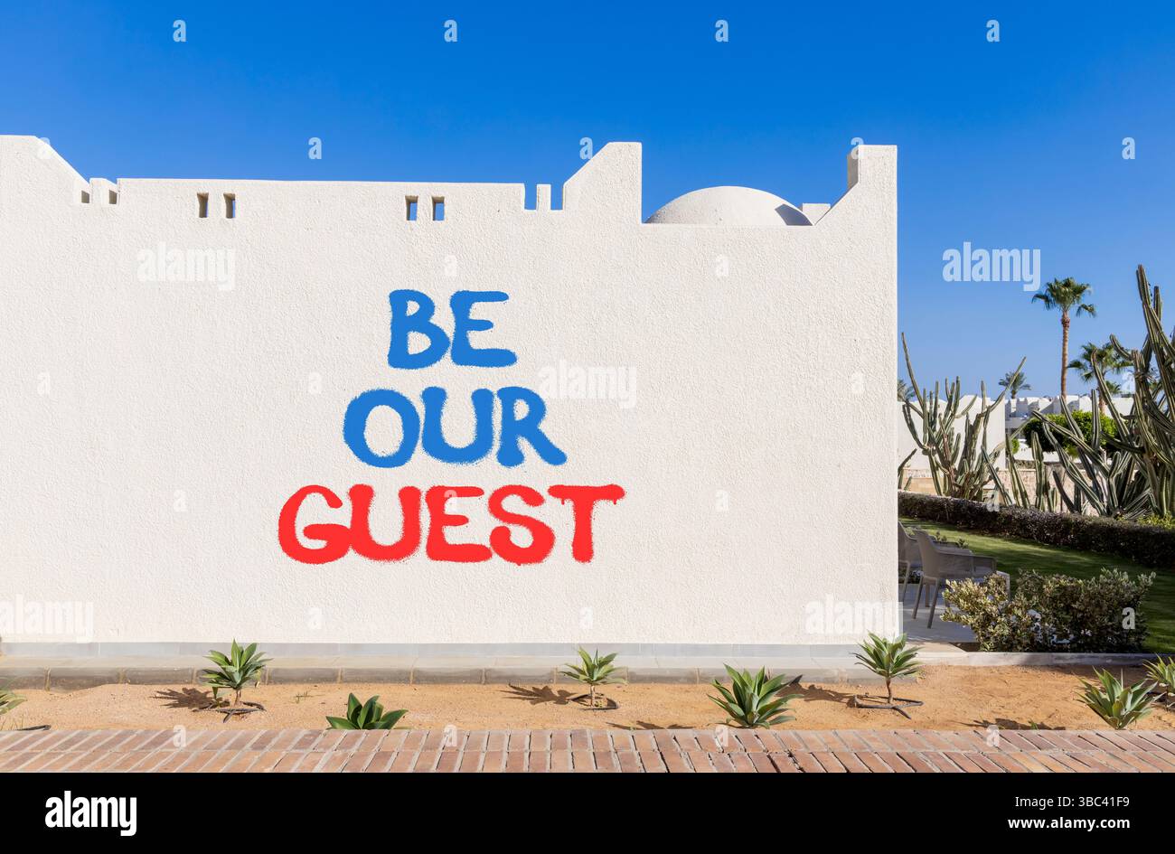 Be our guest symbol. Concept words Be our guest on beautiful white wall ...
