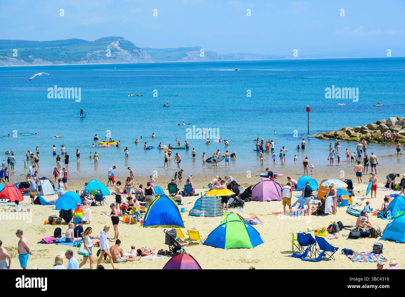 Lyme Regis, Dorset, UK. 18th May, 2025. UK Weather. Visitors and locals ...