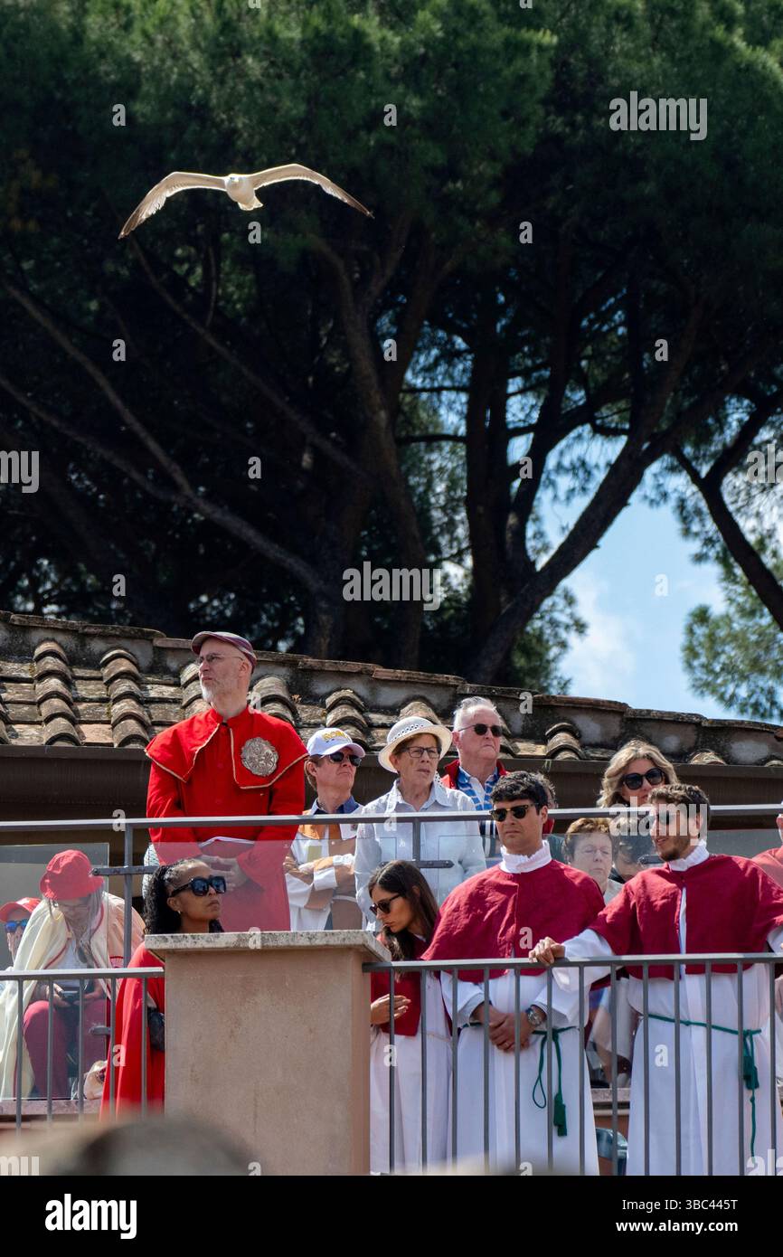 People on a roof follow Pope Leo XIV celebrating the inaugural Mass of ...
