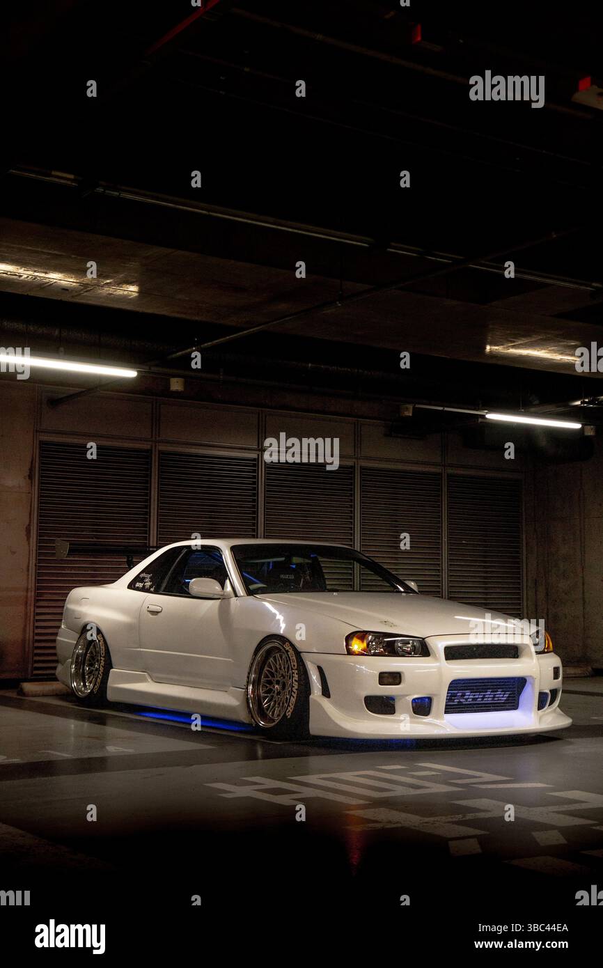 White Nissan Skyline GT‑R R34 parked at a Tokyo underground car meet ...