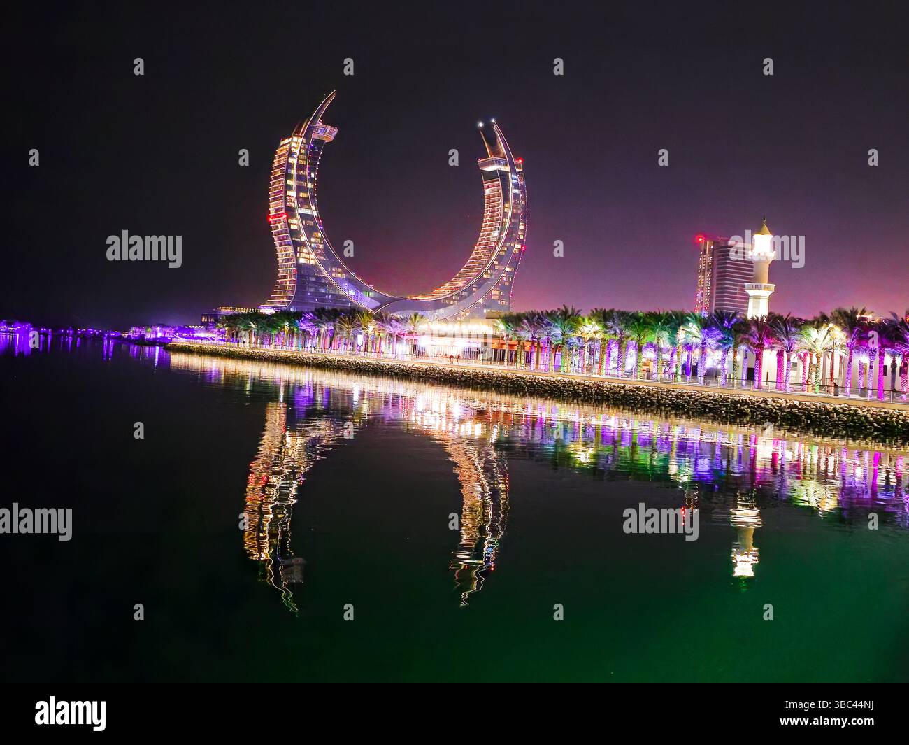 Crescent Tower Lusail and its reflection at night Stock Photo - Alamy