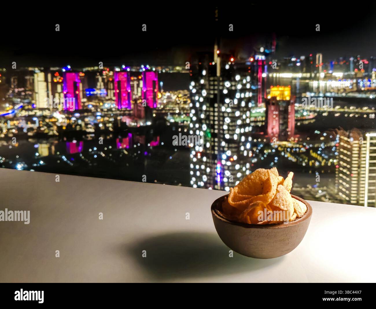 Tourist enjoying colorful skyline of Doha from rooftop coffee shop of ...