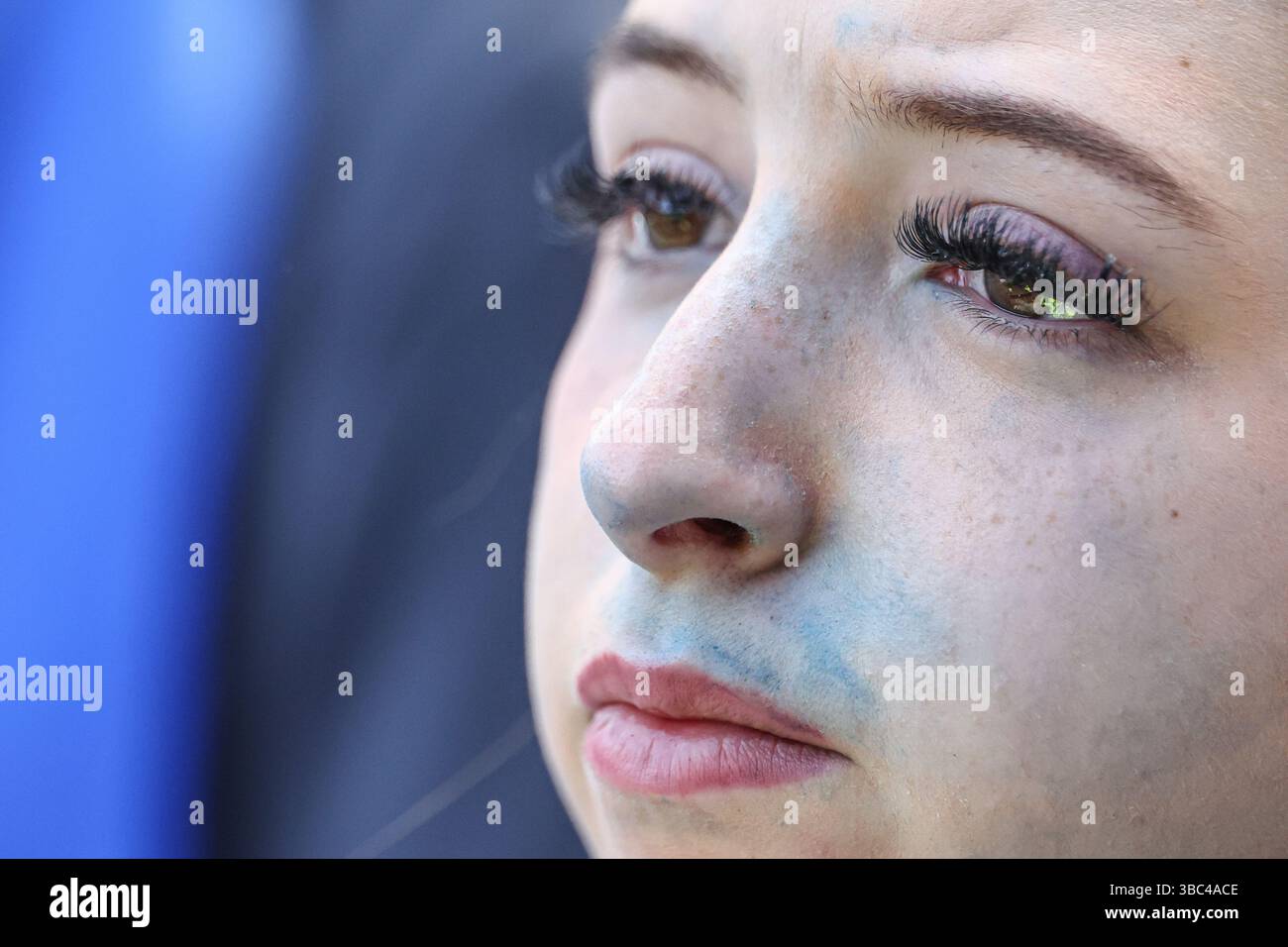 Liverpool, UK. 18th May, 2025. Young fan with blue flare on her face ...