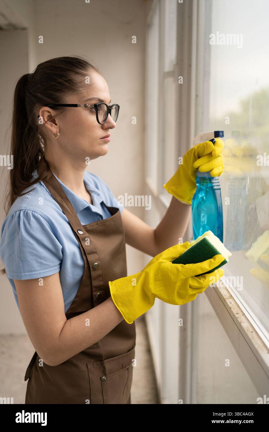Cleaning window with wash spray for hygiene, disinfection, maid service ...