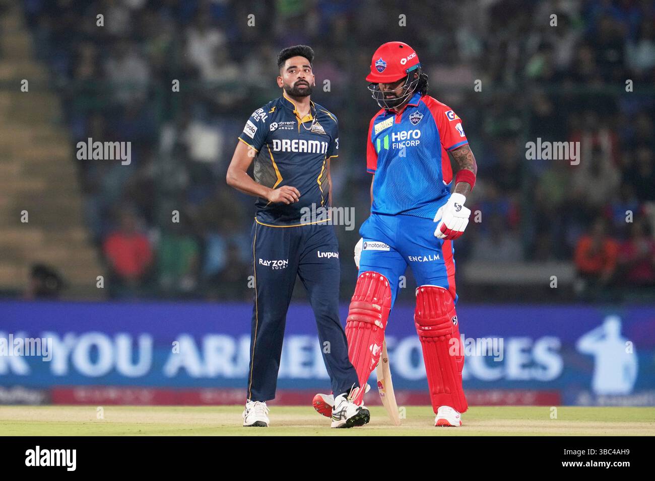 Gujarat Titans' Mohammed Siraj, left, reacts after getting hit for a ...