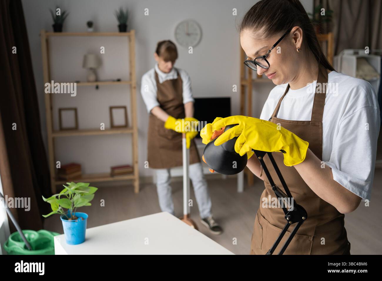 Cleaning service concept. Professional cleaning service women worker team working in house ...
